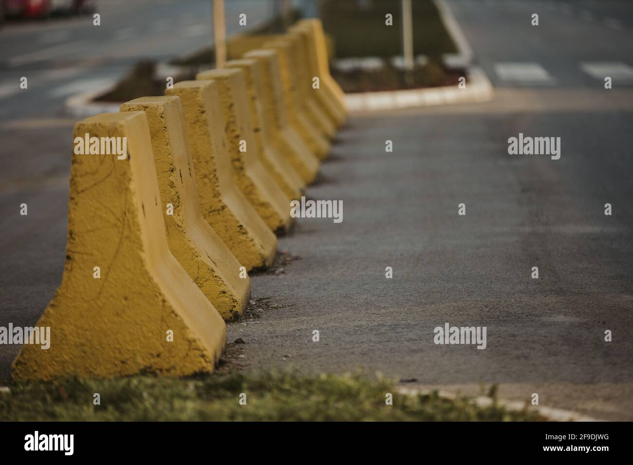 A yellow stone road separators in the street during daytime Stock Photo ...