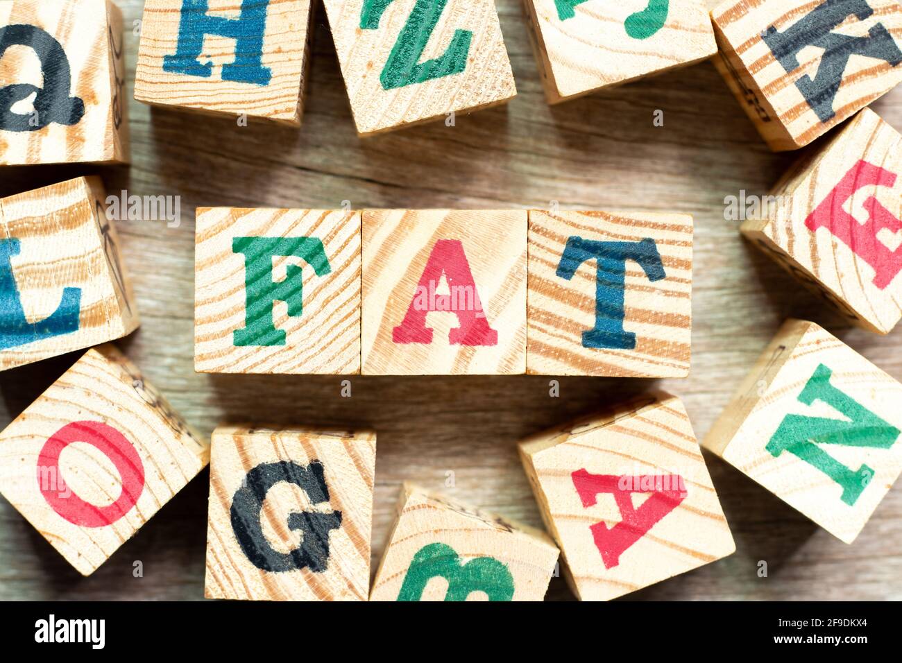 Alphabet letter block in word FAT (Obesity or abbreviation of factory ...