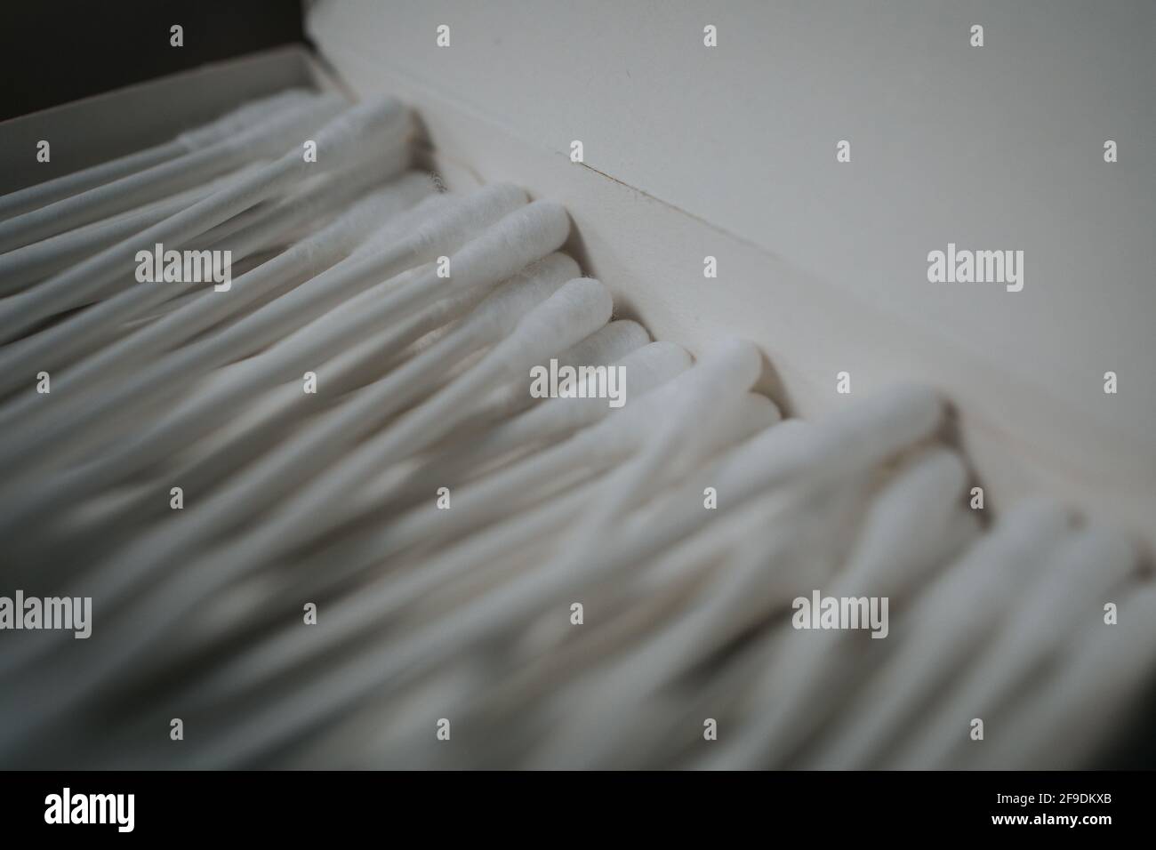 A closeup shot of white plastic ear sticks in a small paper box Stock ...