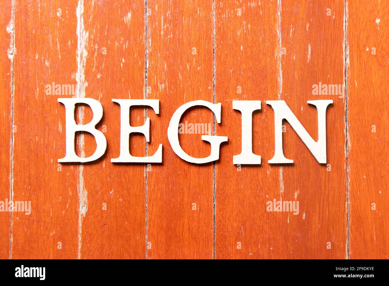 Alphabet letter in word begin on old red color wood plate background ...