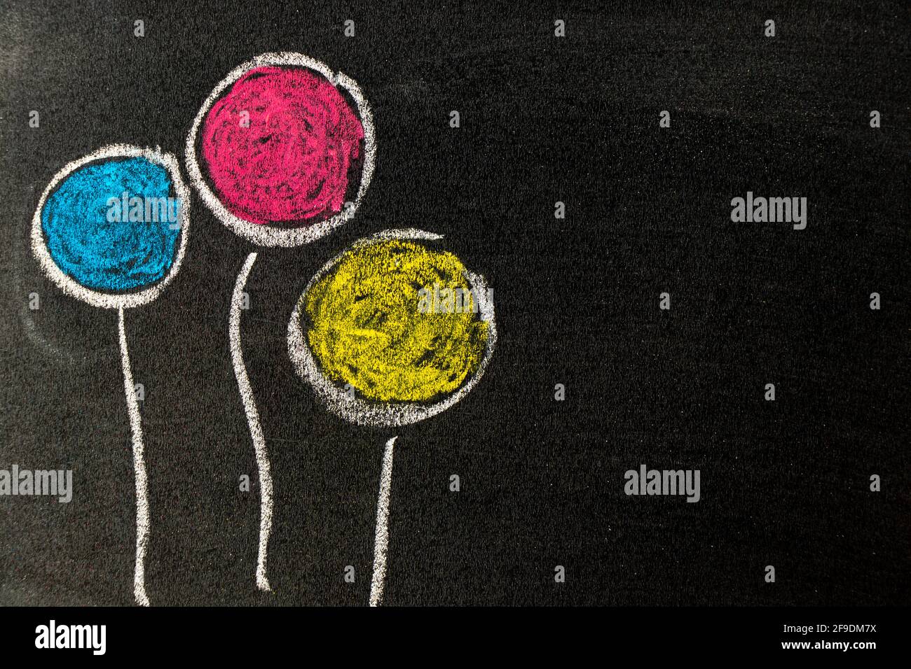 Colorful chalk hand drawing in balloon shape on blackboard or ...