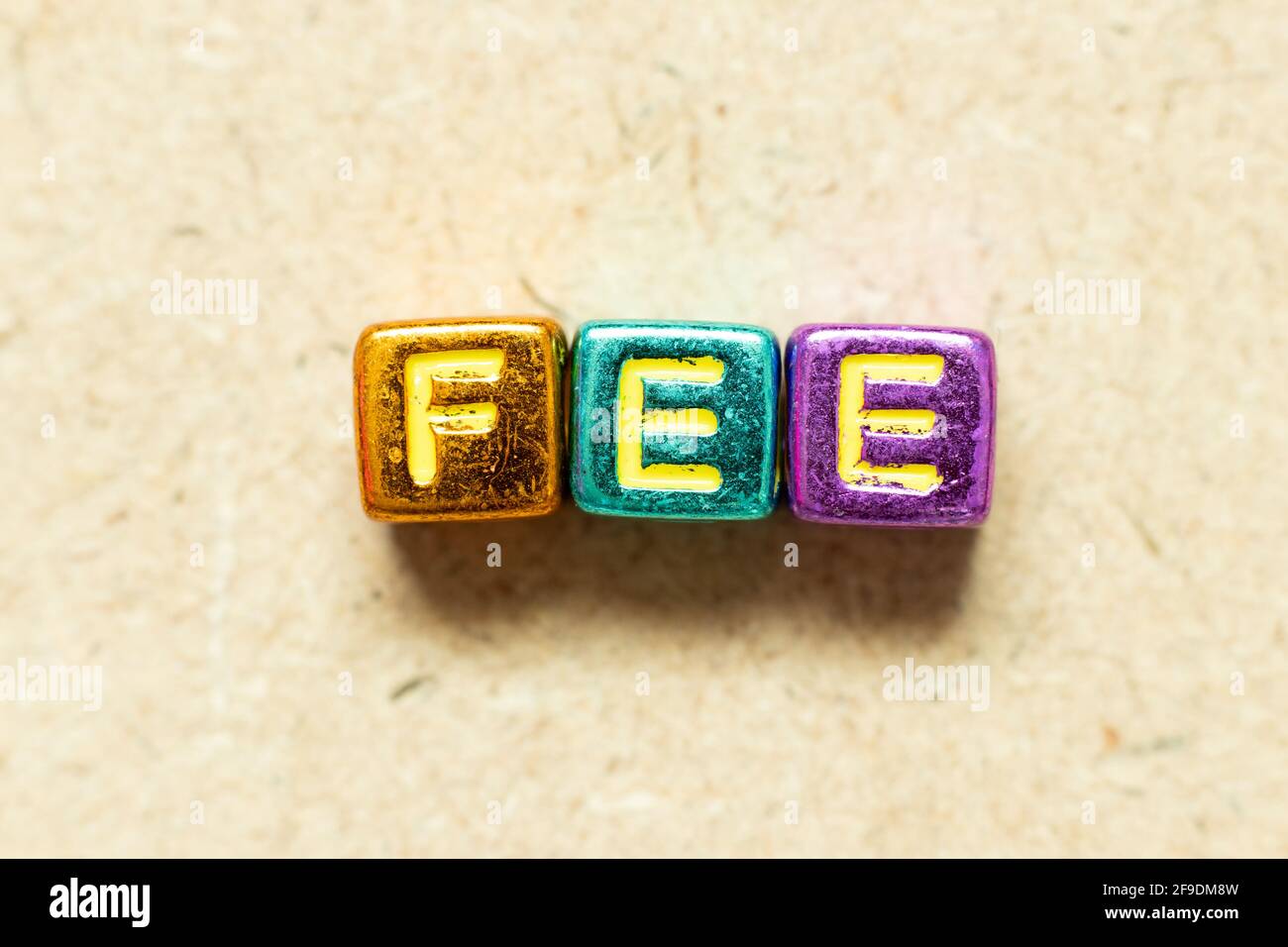 Metallic color alphabet letter block in word fee on wood background ...