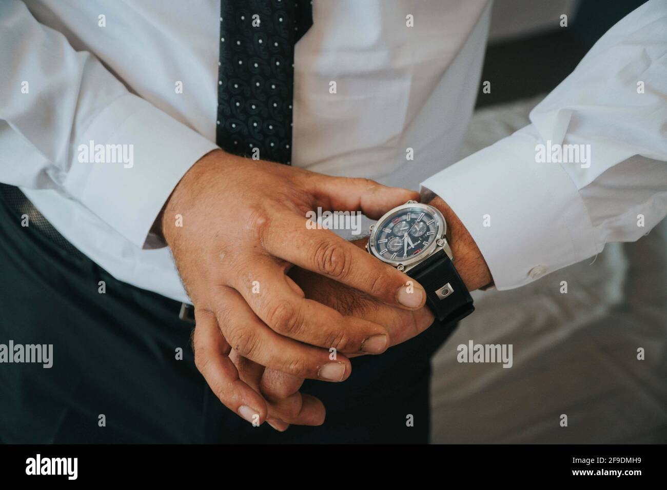 Businessman adjusting watch hi-res stock photography and images - Alamy