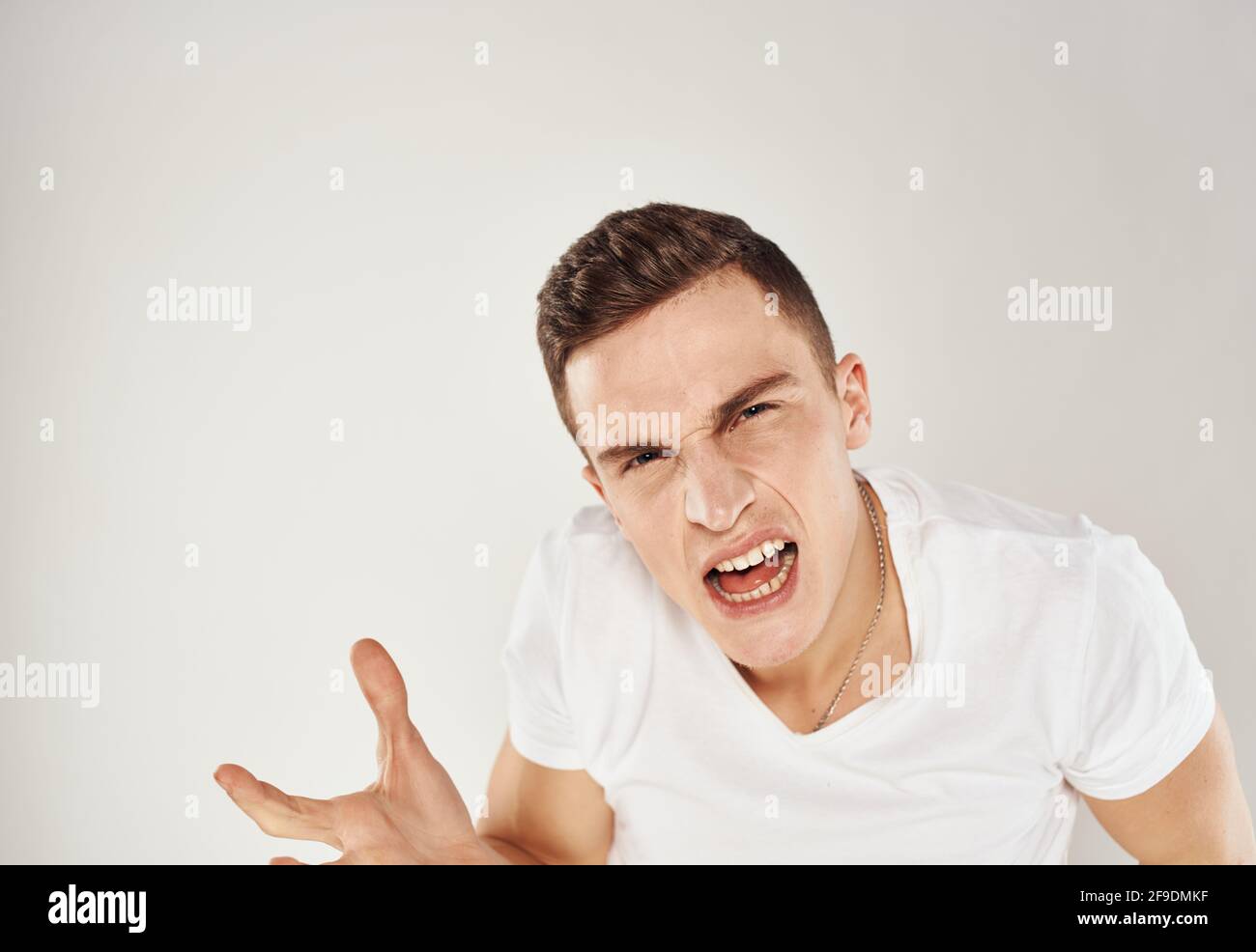 man gesturing with his hands indignant look light background cropped ...