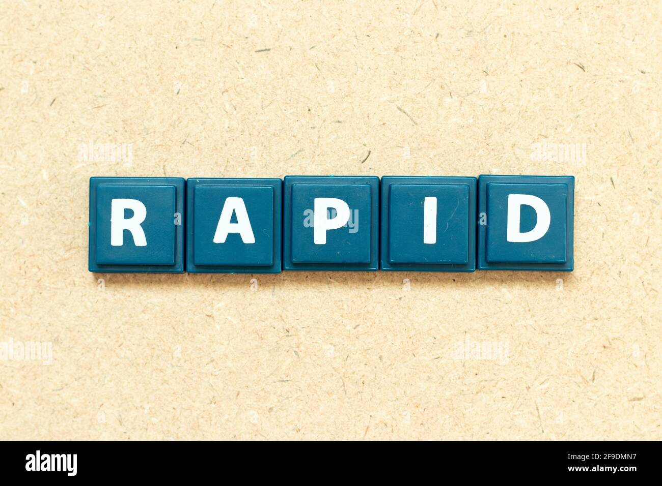 Tile alphabet letter in word rapid on wood background Stock Photo - Alamy