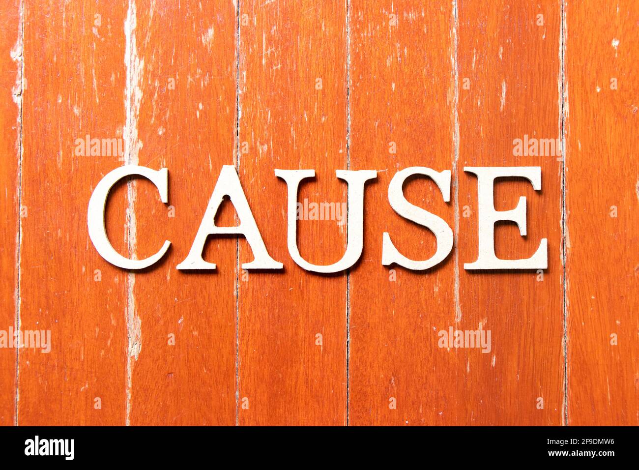 Alphabet letter in word cause on old red color wood plate background ...