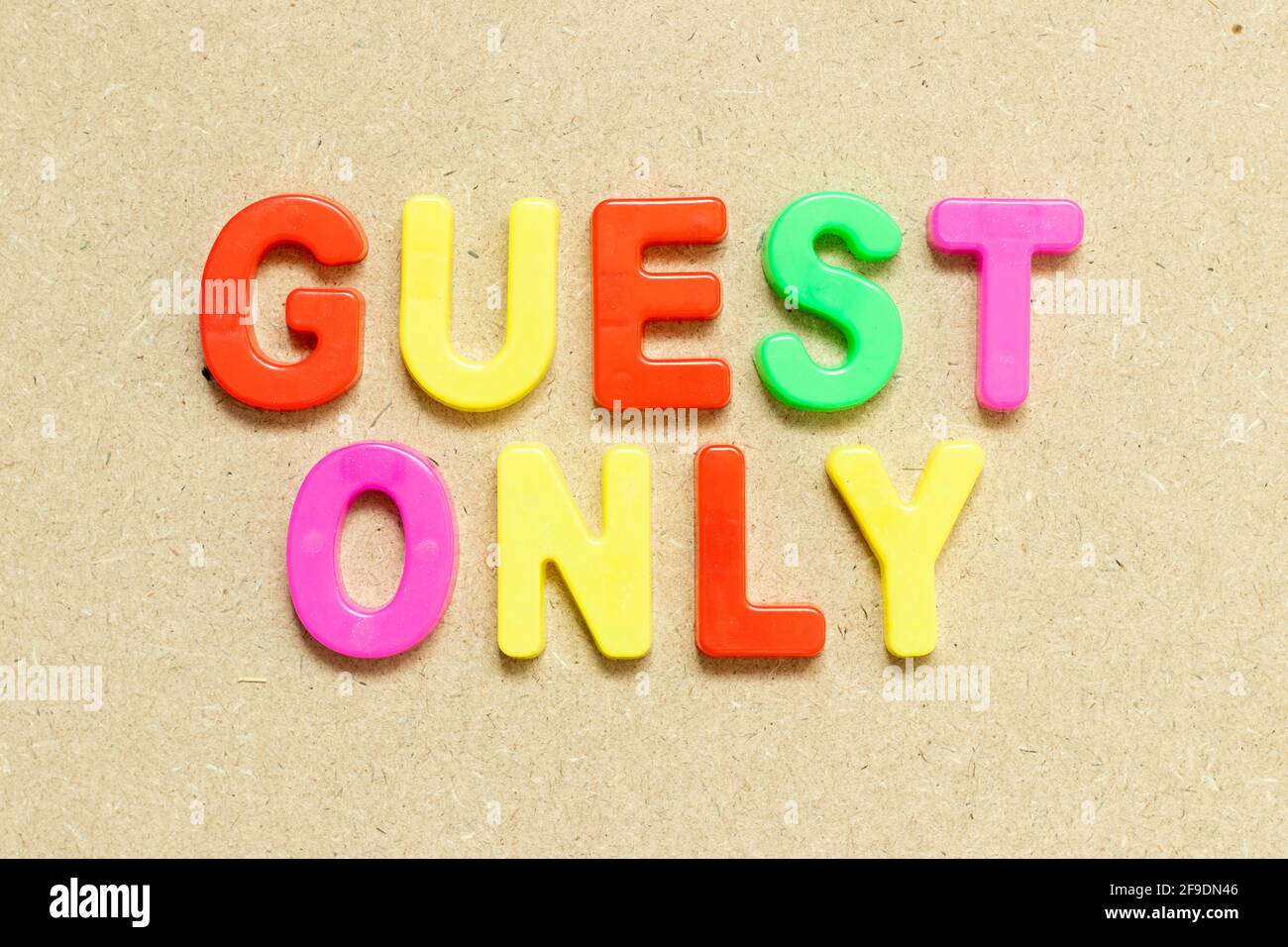 Color alphabet letter with word guest only on wood background Stock ...