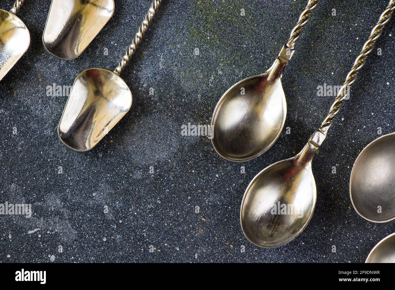 A top view of a collection of different vintage spoons on the table ...