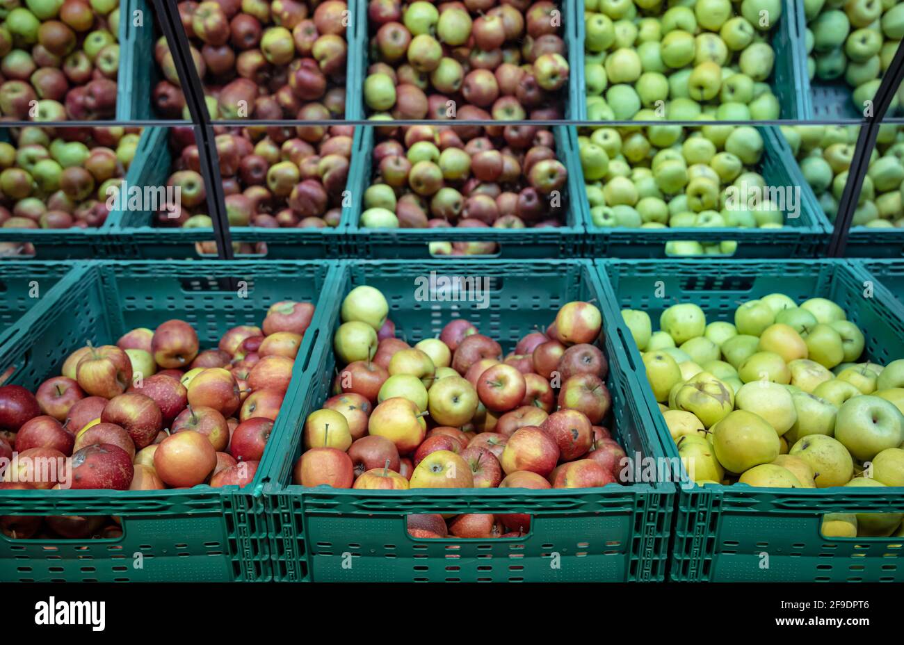 Fresh natural apples in crates on the supermarket counter. Selection of ...