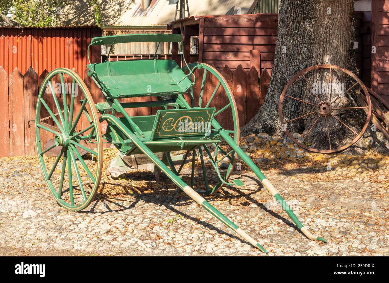 One green vintage cart under a tree Stock Photo - Alamy