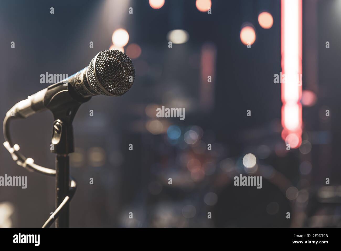 Close up of a microphone on a concert stage with beautiful lighting ...