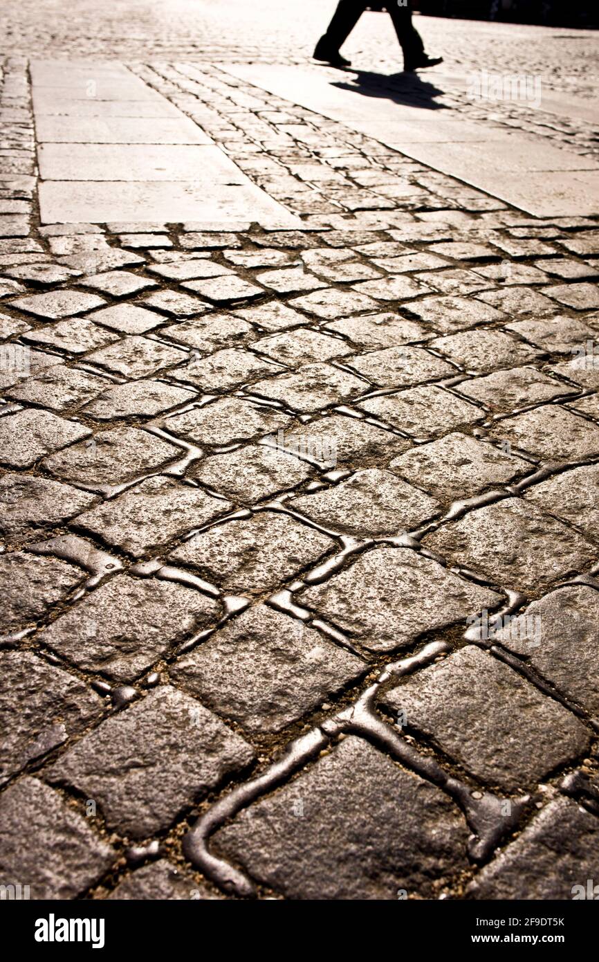 shadow of a person walking on a city street Stock Photo - Alamy