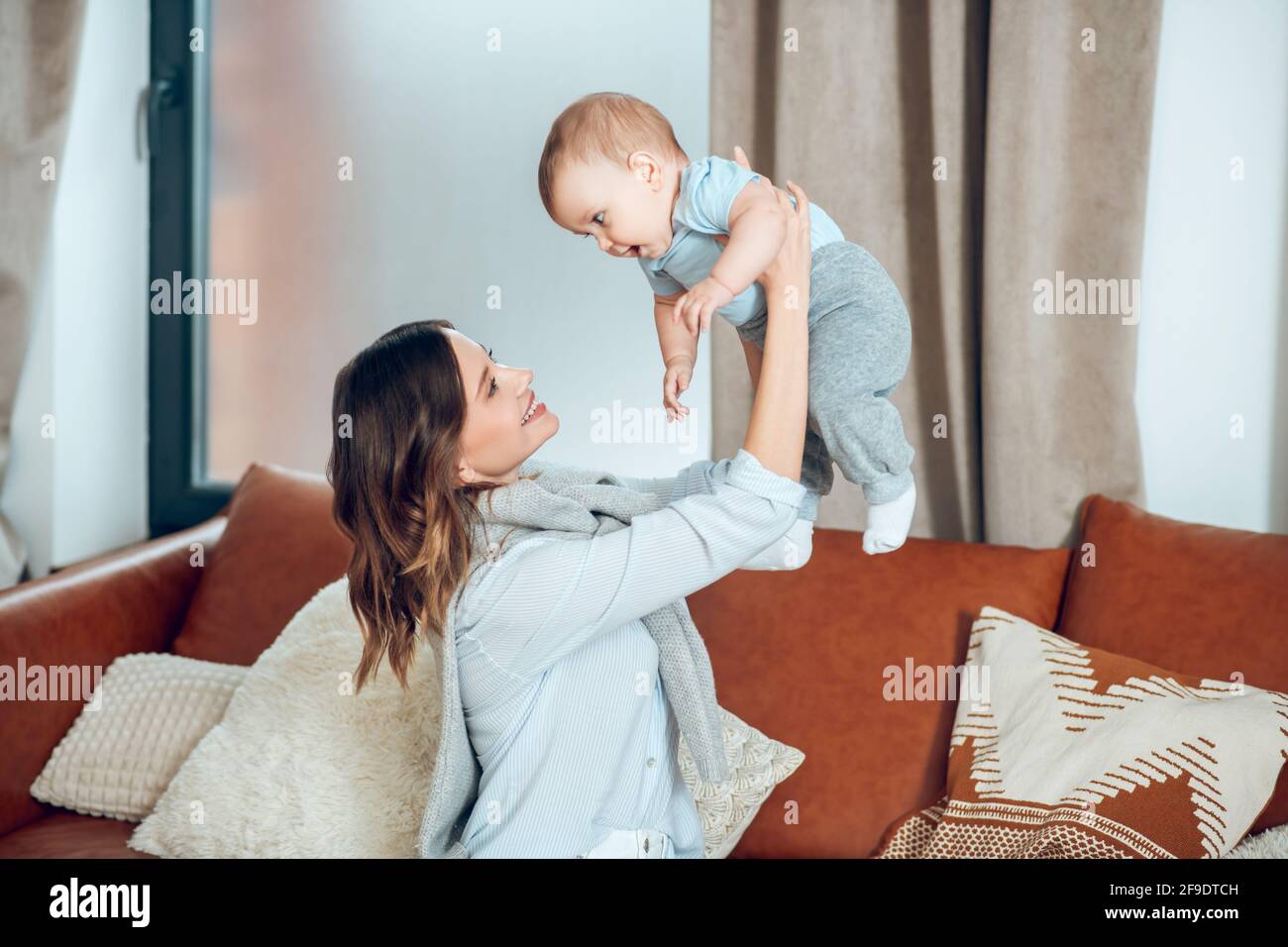 Happy small kid raising arms hi-res stock photography and images - Alamy