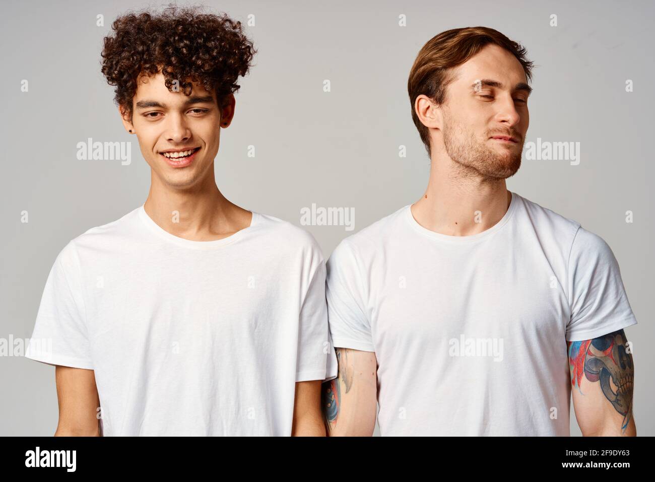 two men in white t-shirts are standing next to friendship emotions ...