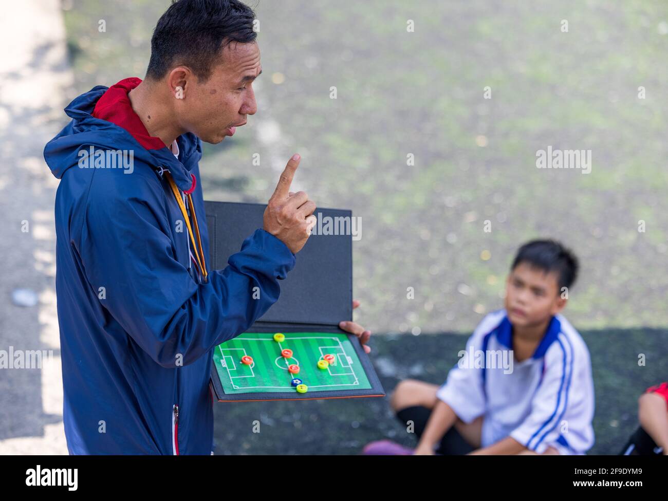 Football soccer training for kids. Coach explaining the game plan ...