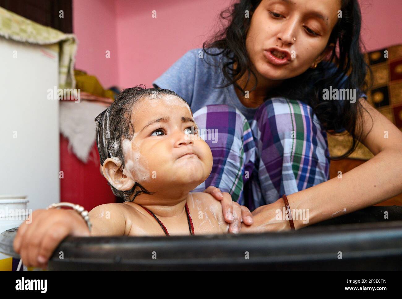 Young mother bathing cheerful baby with soap Stock Photo - Alamy