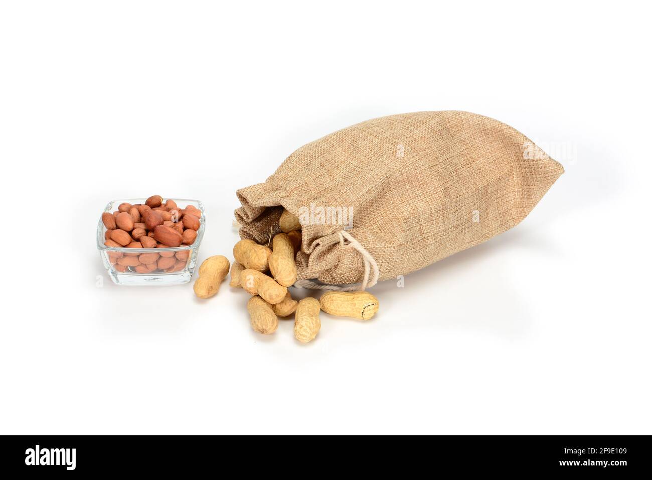 Peanuts. Jute burlap sack full of peanuts and glass bowl with peeled ...
