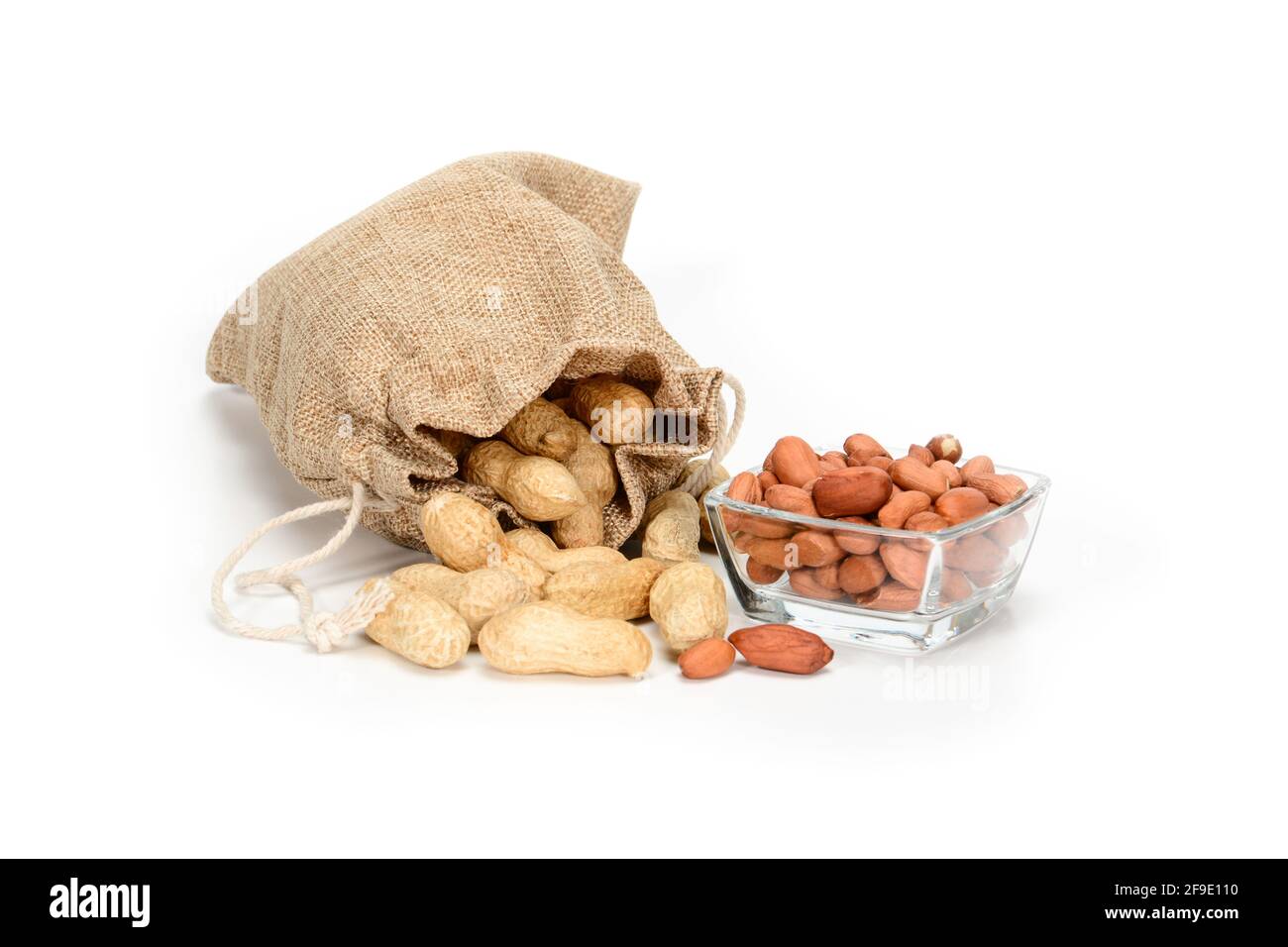 Peanuts. Jute burlap sack full of peanuts and glass bowl with peeled ...