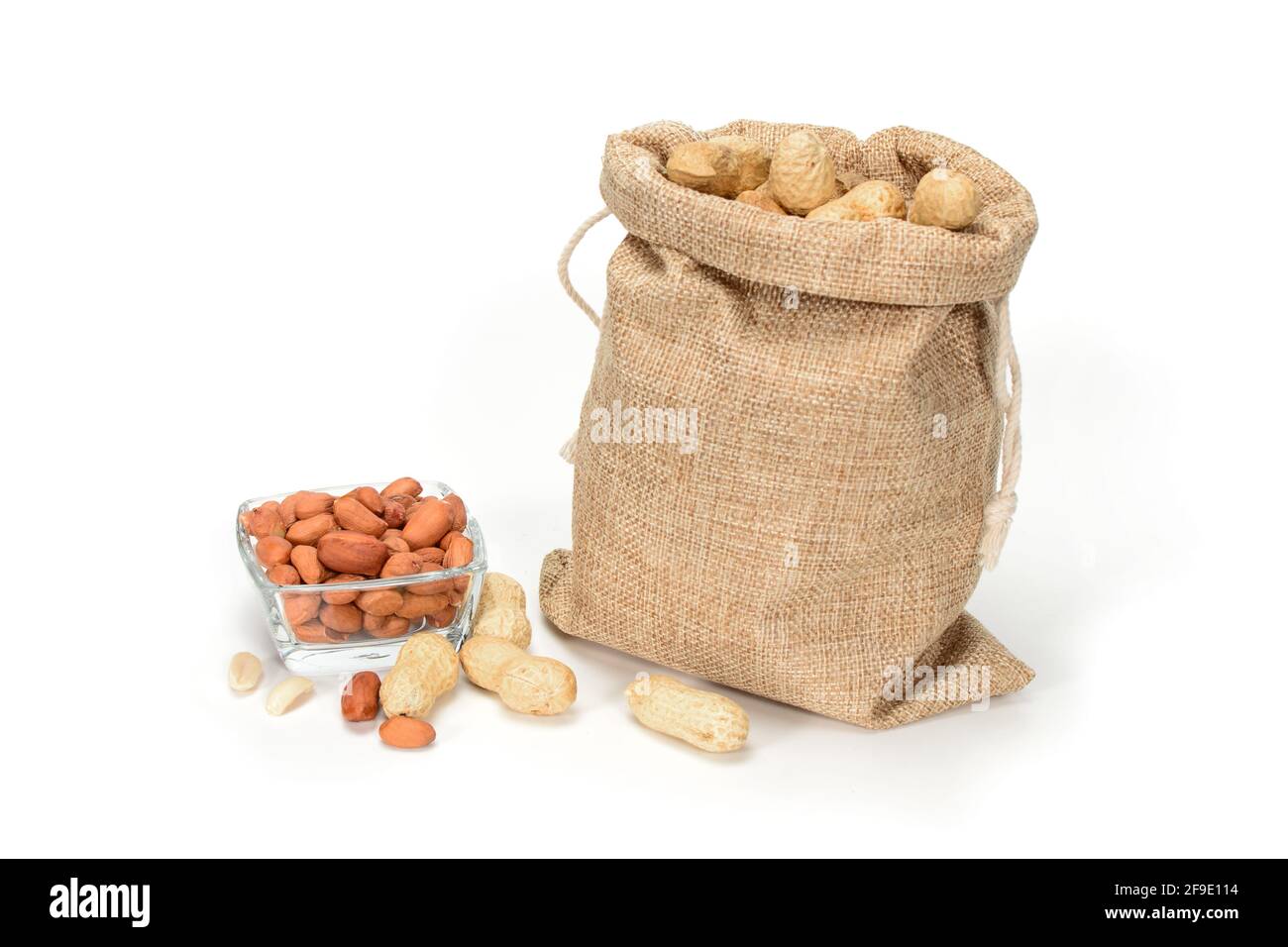 Peanuts. Jute burlap sack full of peanuts and glass bowl with some ...