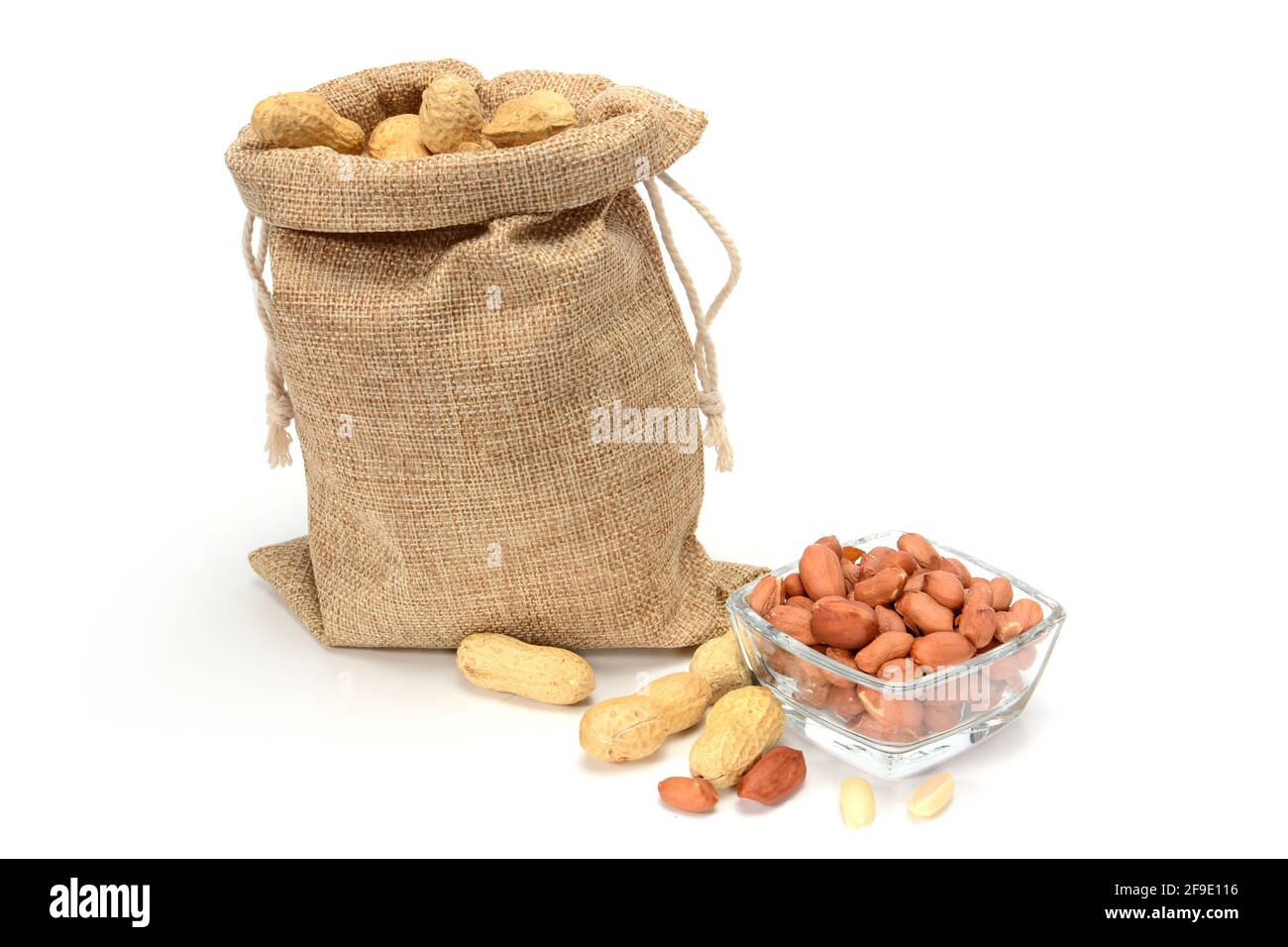 Peanuts. Jute burlap sack full of peanuts and glass bowl with some ...