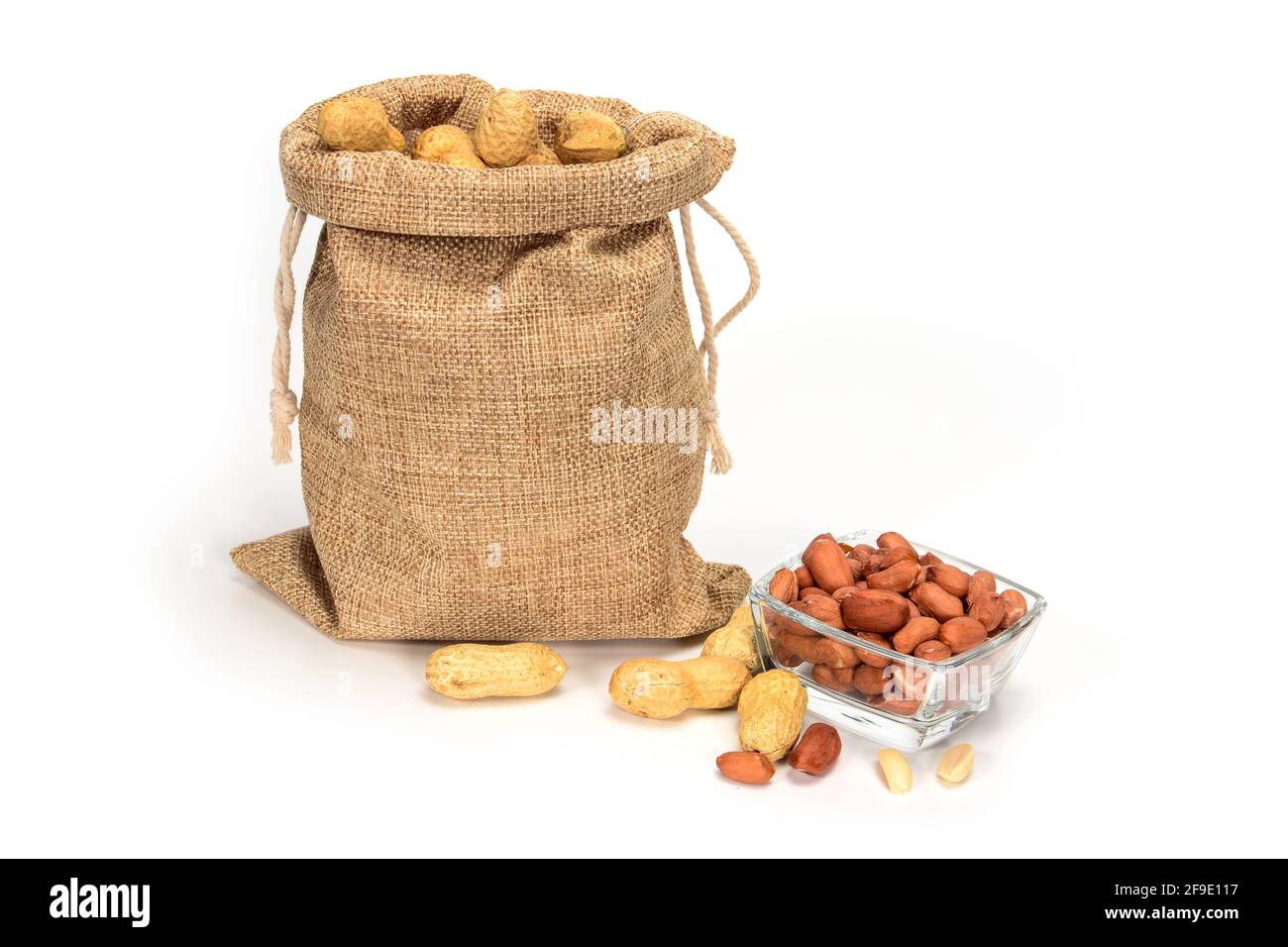 Peanuts. Jute burlap sack full of peanuts and glass bowl with some ...