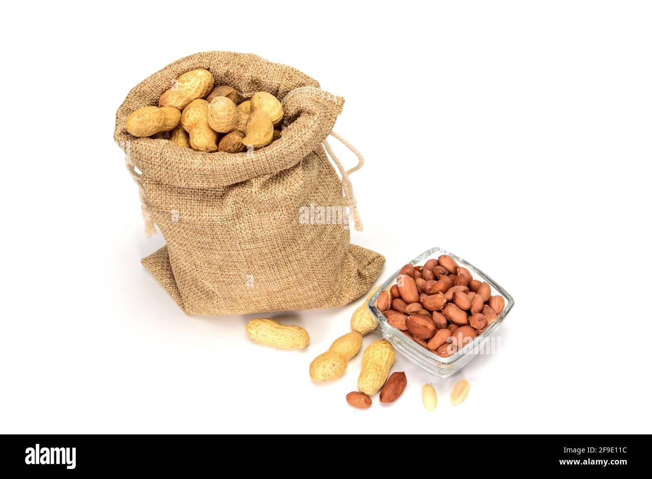 Peanuts. Jute burlap sack full of peanuts and glass bowl with peeled ...