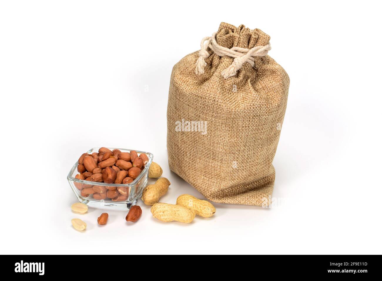 Peanuts. Jute burlap sack full of peanuts and glass bowl with some ...
