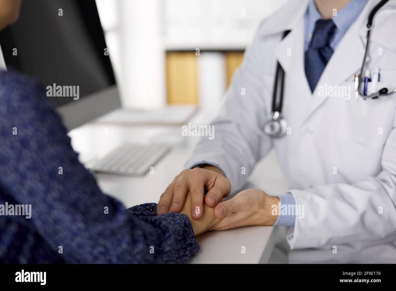 Friendly doctor reassuring his female patient, close-up. Medical ethics ...