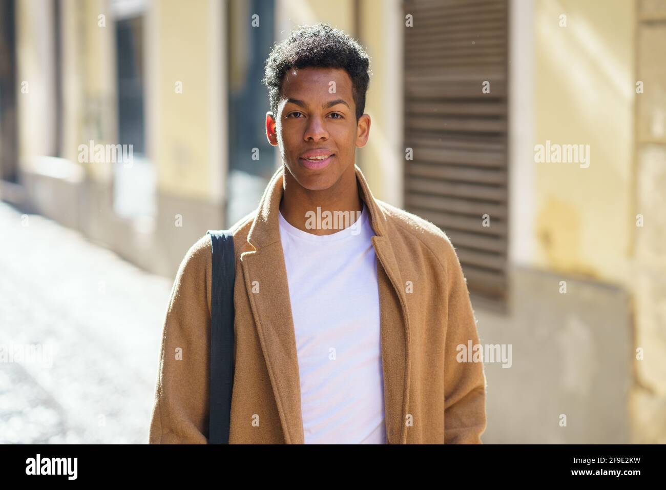 Young Cuban man standing in the street Stock Photo - Alamy
