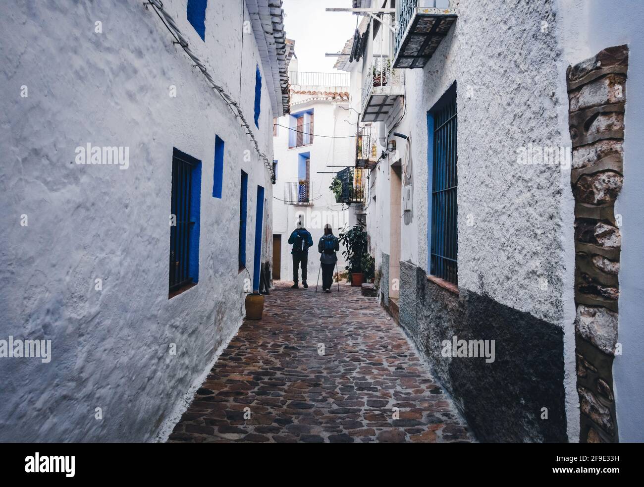 The tourists exploring the Ain, a small town with white buildings in ...