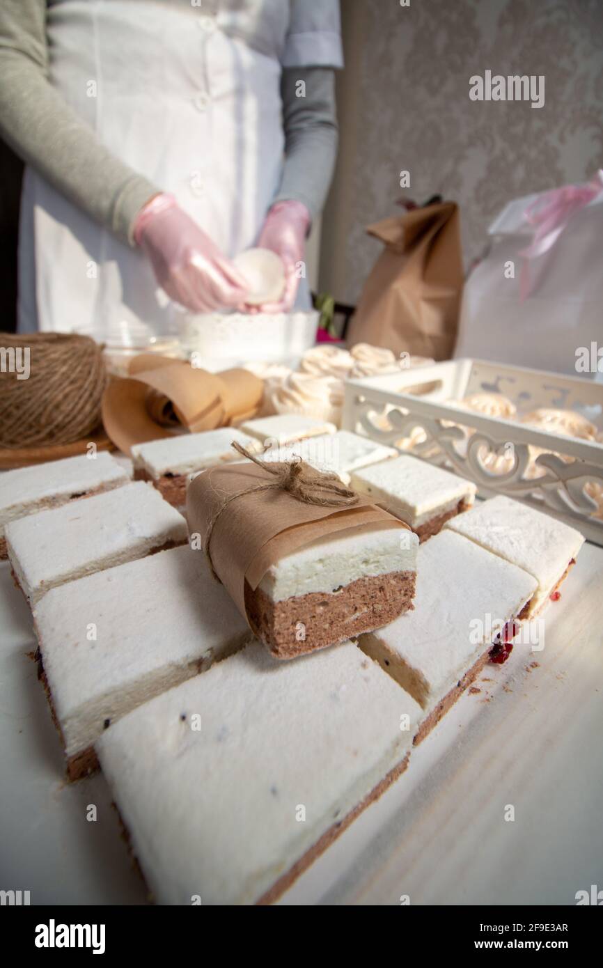 A woman is packing homemade marshmallows. Cooking marshmallows at home ...