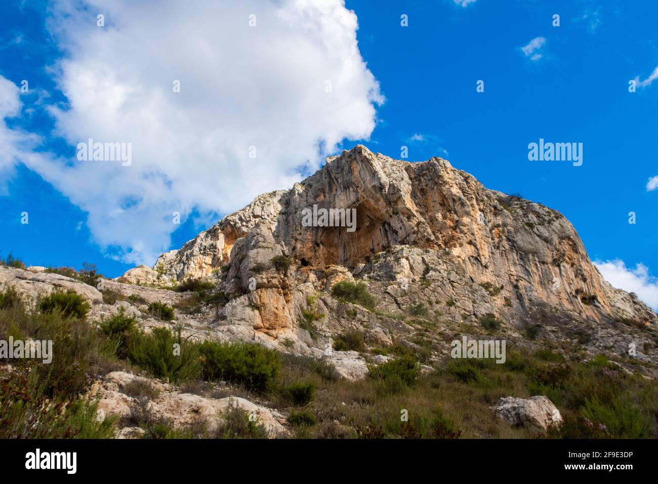 A low angle shot of a rocky mountain under a blue sky in winter Stock ...