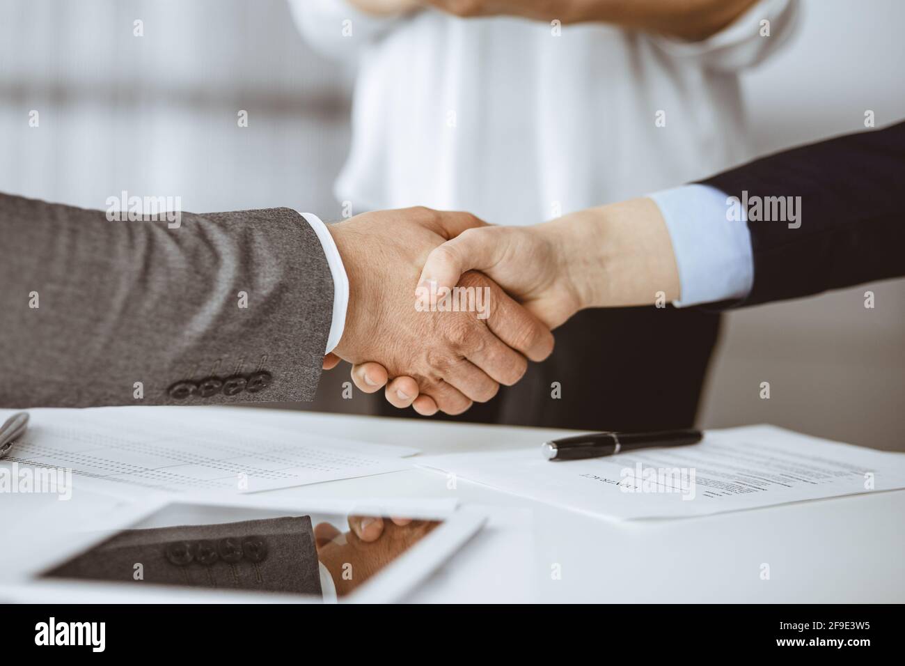 Business people shaking hands finishing contract signing, close-up ...
