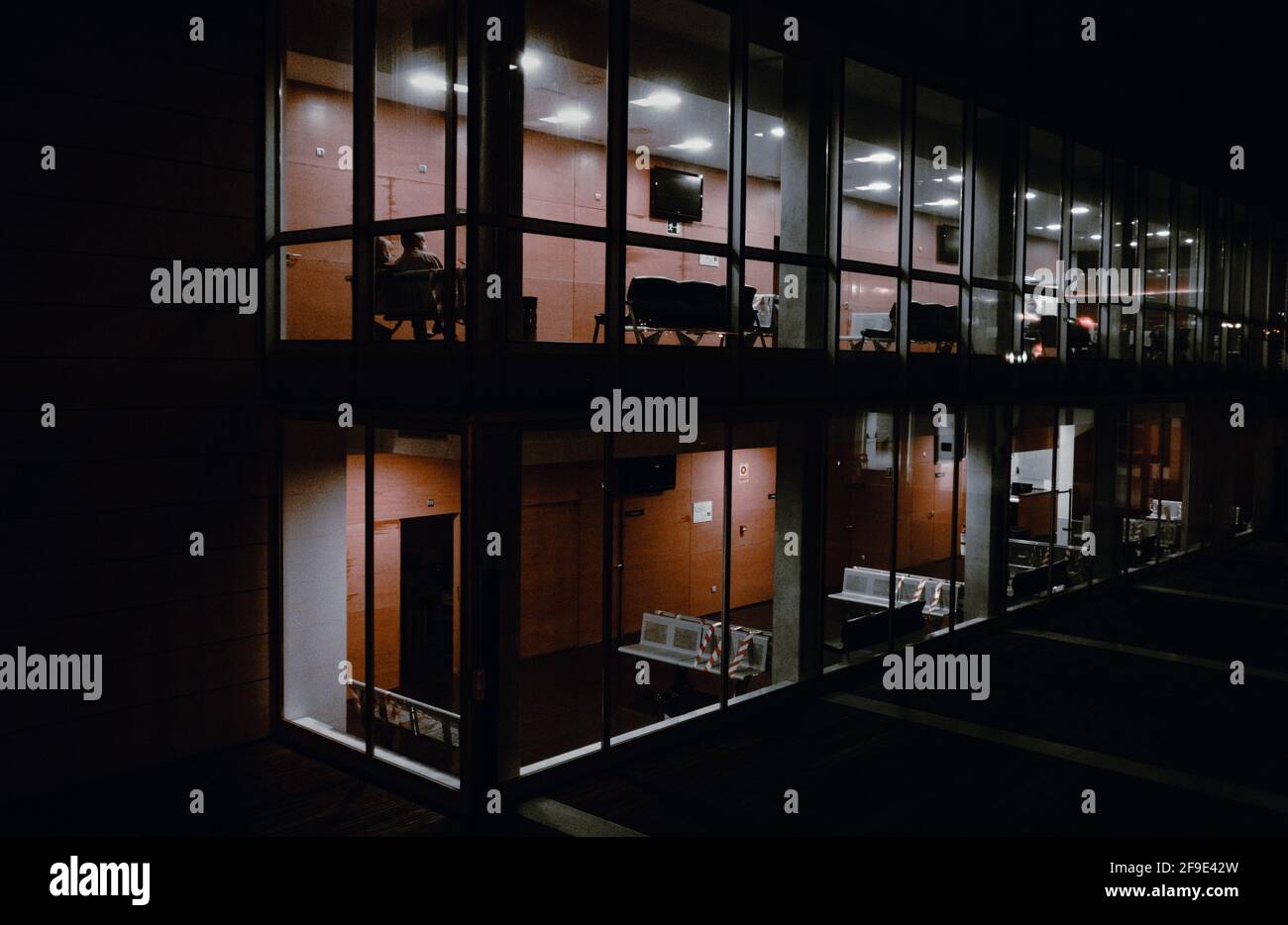 A beautiful brightly lit two-story modern building with window walls, a ...