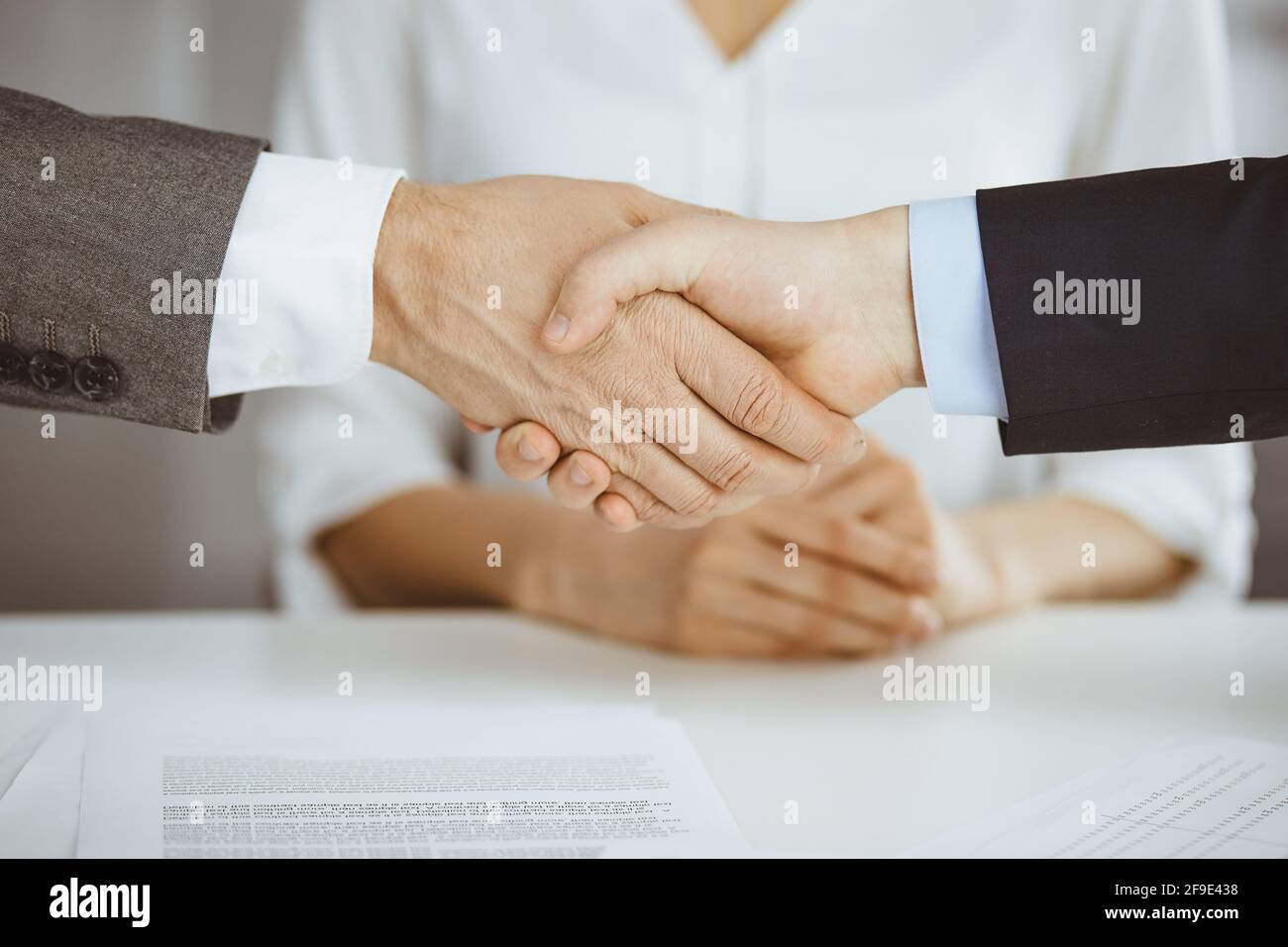 Business people shaking hands finishing contract signing, close-up ...