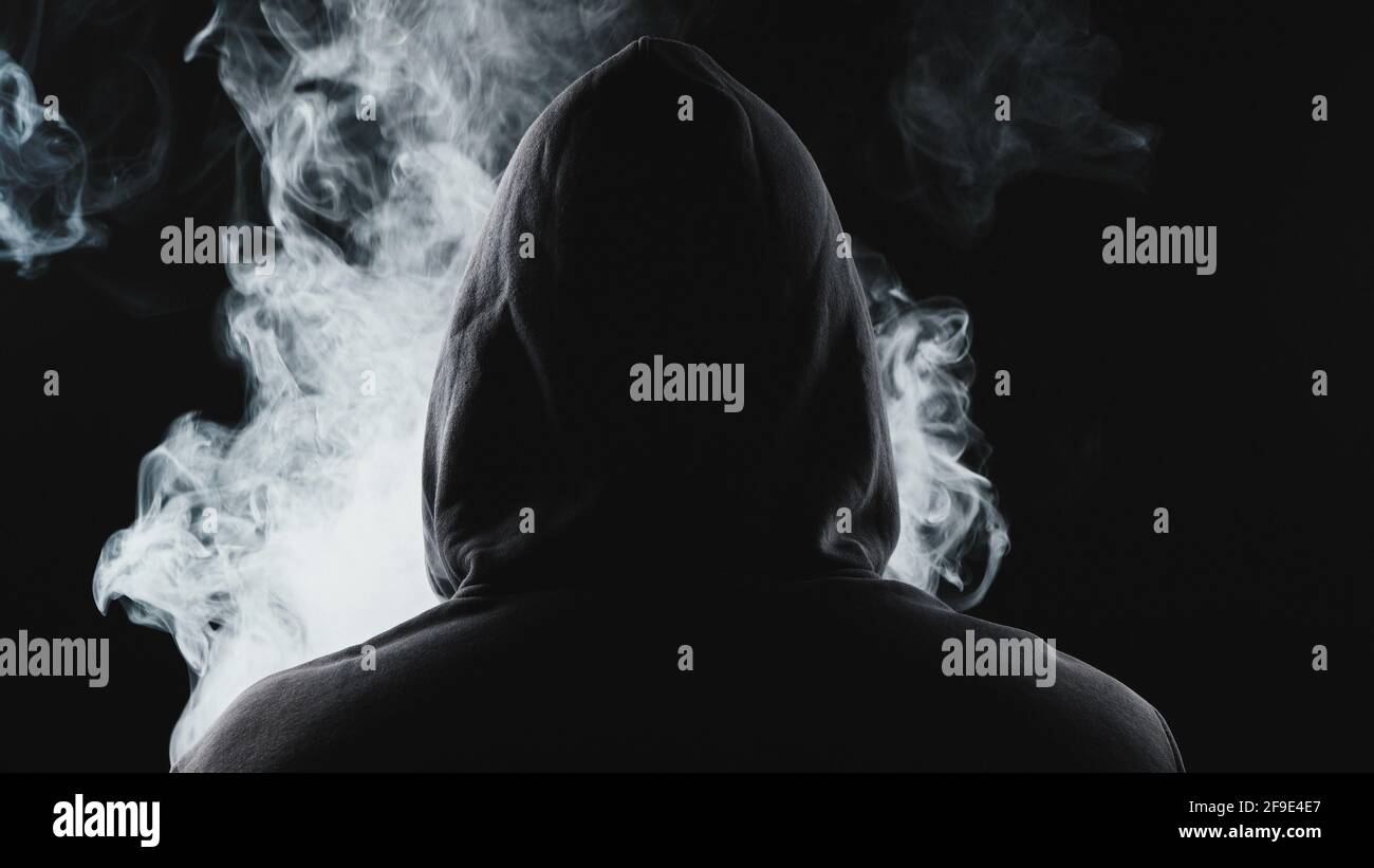 Photo of smoker in the hood from back Stock Photo - Alamy