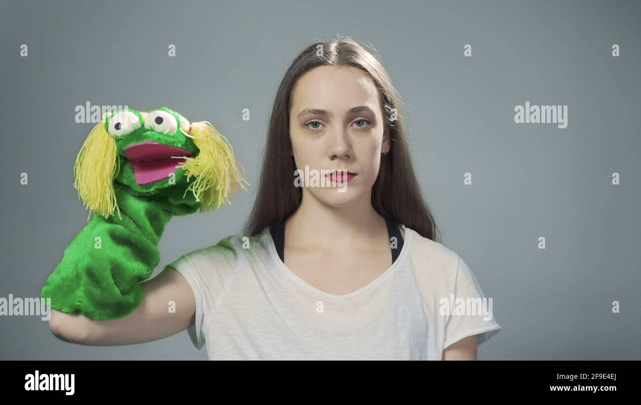 Photo of woman with handmade doll on grey Stock Photo - Alamy