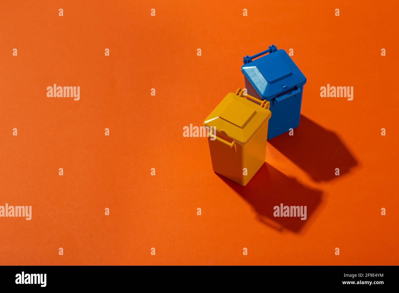 Yellow and blue trash can on an orange background. Infection control ...