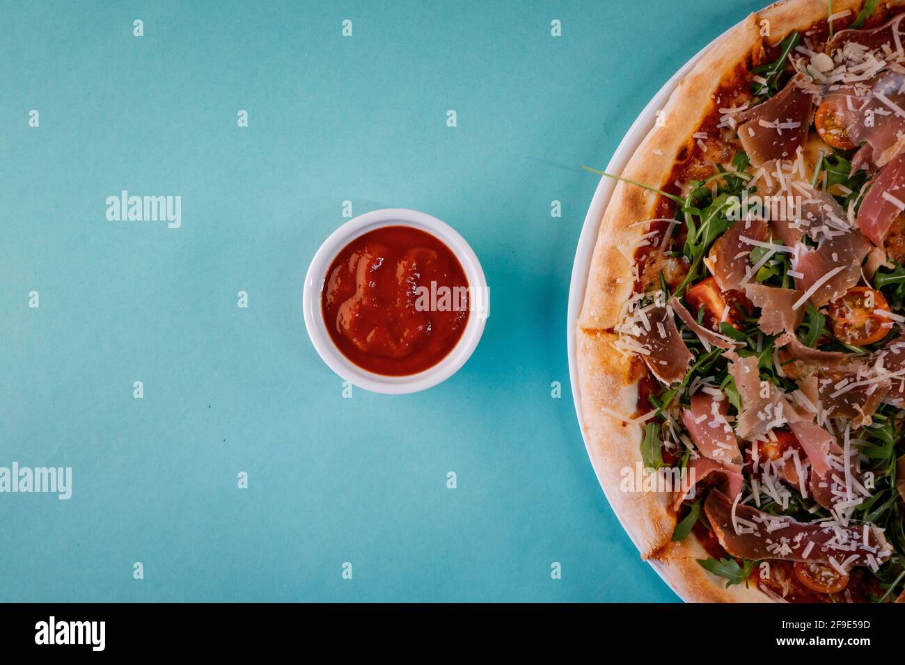 A top view of delicious prosciutto pizza with ketchup isolated on a ...