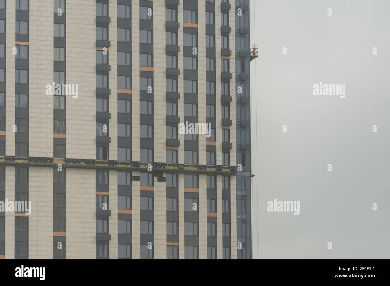 The high-rise facade of a residential and commercial building with ...