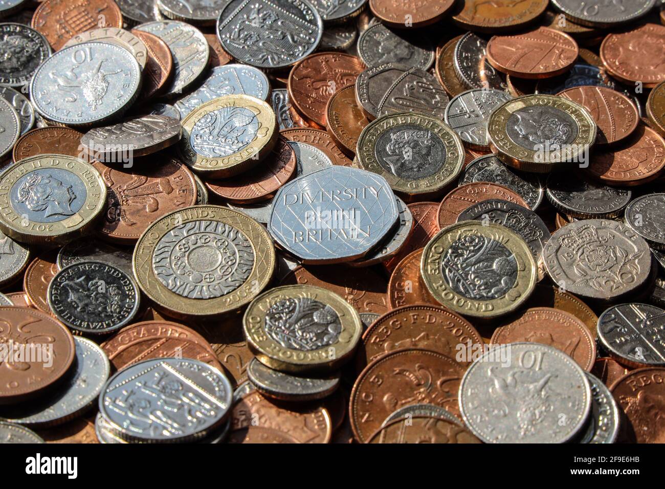 British metric coins on a table with 1p, 2p, 5p, 10p 20p, 50p, £1 and £2 coins included. A ...