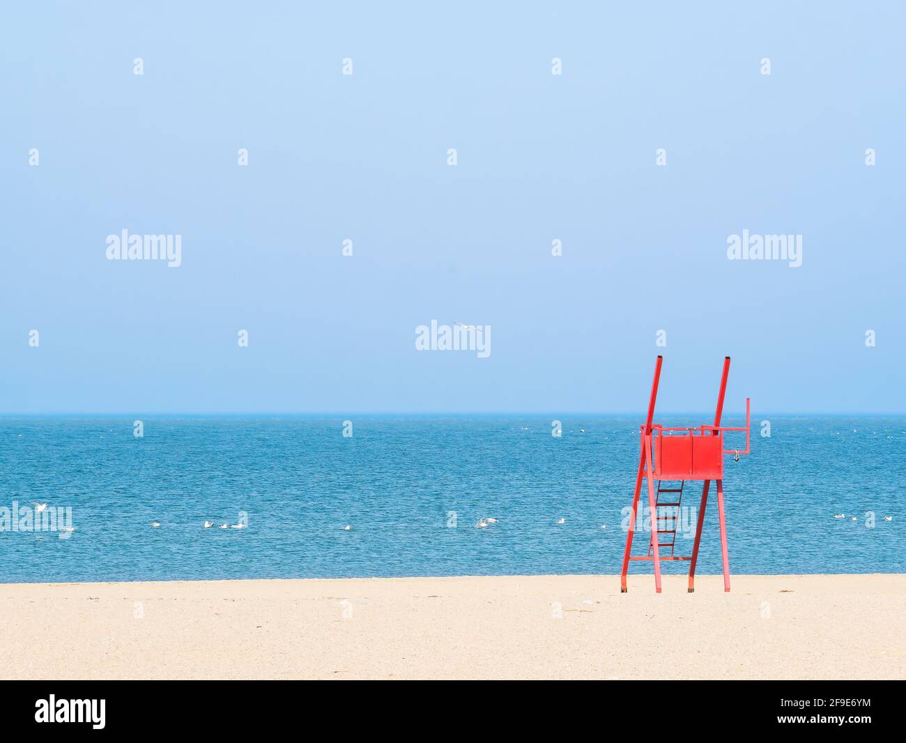 Red lifeguard chair on an empty beach Stock Photo - Alamy
