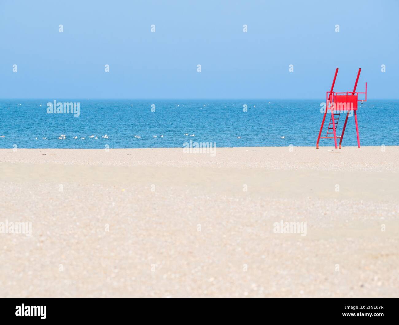 Red lifeguard chair on an empty beach Stock Photo - Alamy
