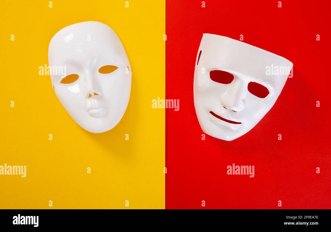 carnival white mask on red and yellow background Stock Photo - Alamy
