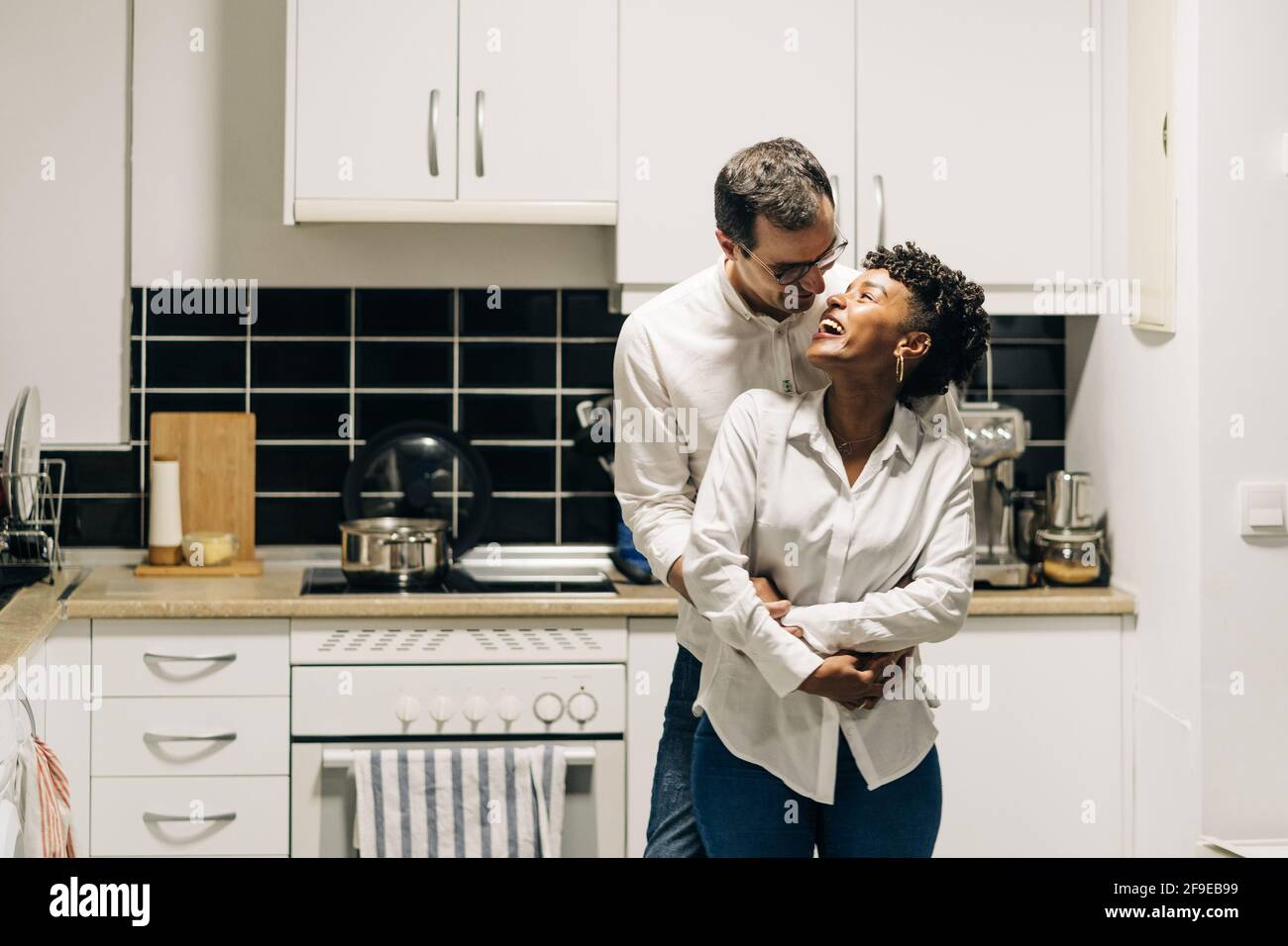Amorous couple standing in kitchen hi-res stock photography and images ...