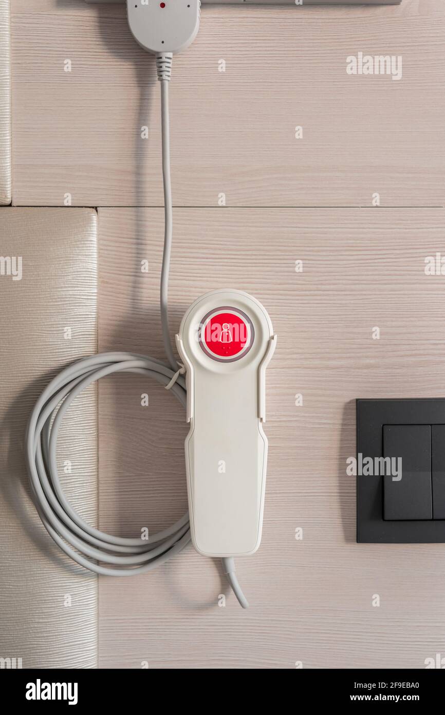 Close up of nurse call system with emergency buttons installed near bed ...