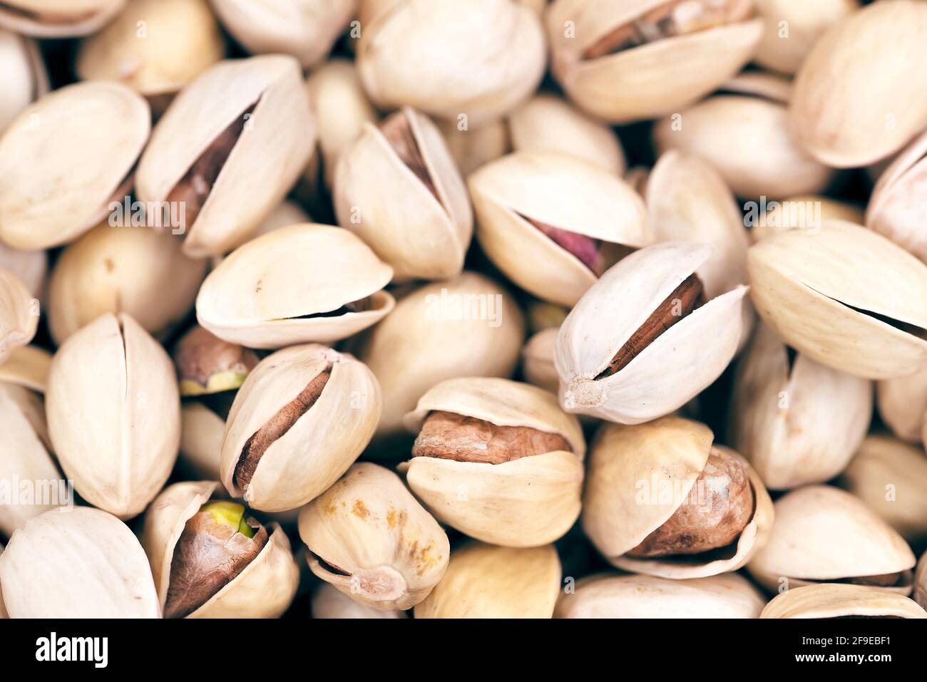 Roasted and salted pistachios in shell background Stock Photo - Alamy
