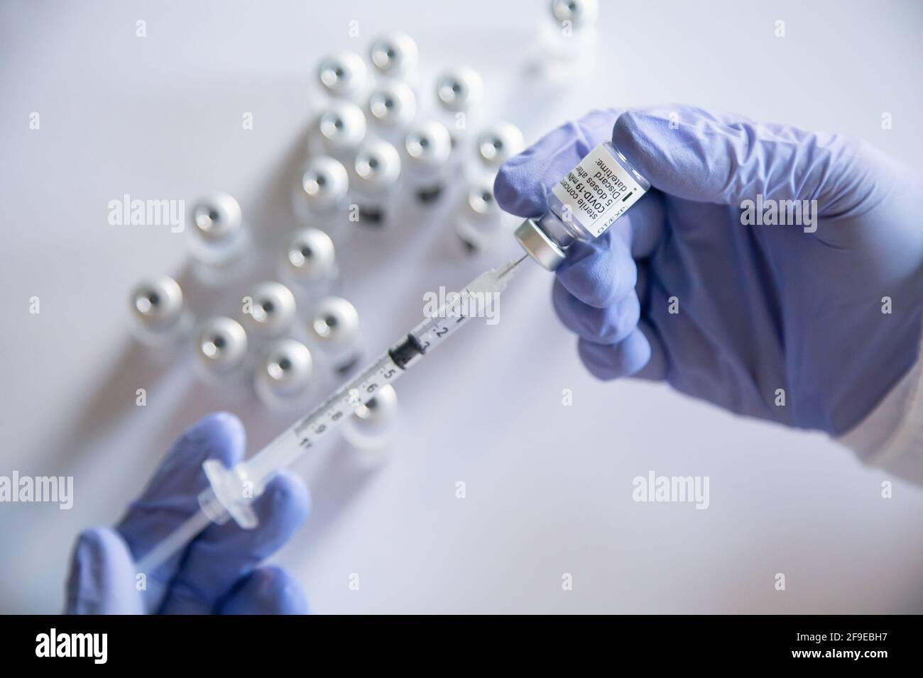 Anonymous female doctor with vaccine bottle and syringe Stock Photo - Alamy