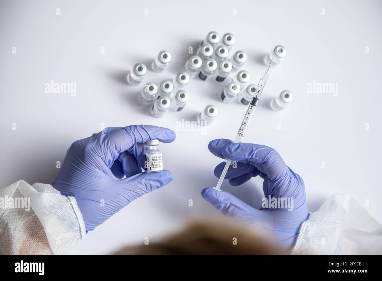 Anonymous female doctor with vaccine bottle and syringe Stock Photo - Alamy