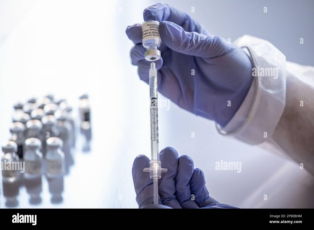 Anonymous female doctor with vaccine bottle and syringe Stock Photo - Alamy